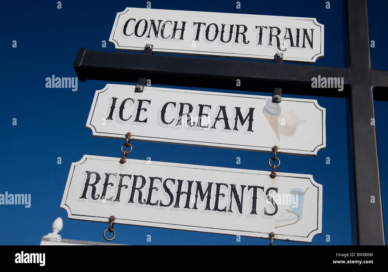 Signs for refreshments and attractions against a blue sky at Mallory ...