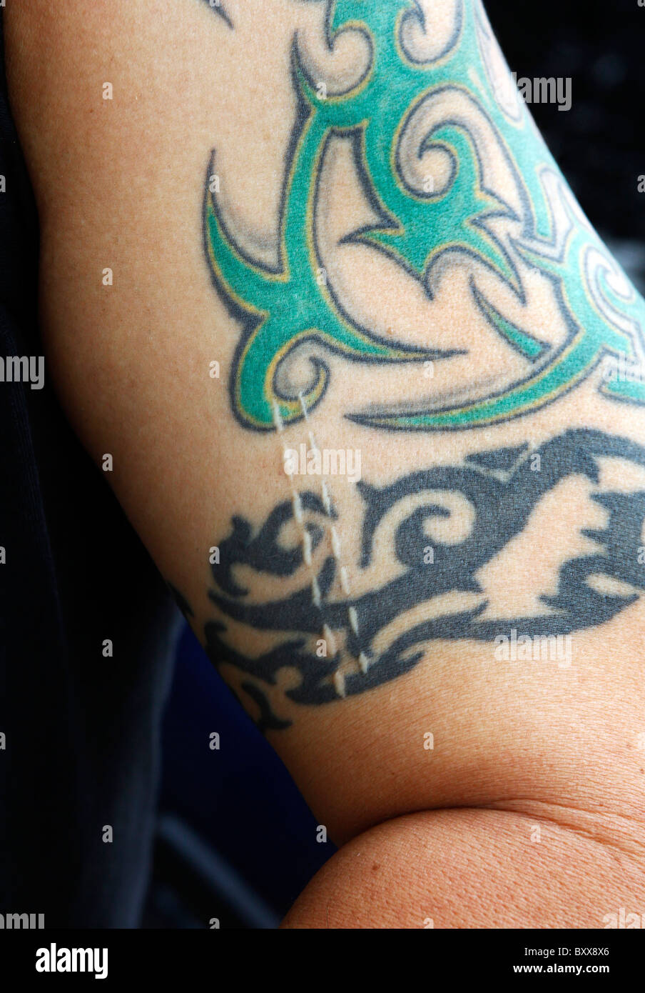Member of the notorious youth gang Seven-Seven display his tattoo and ...