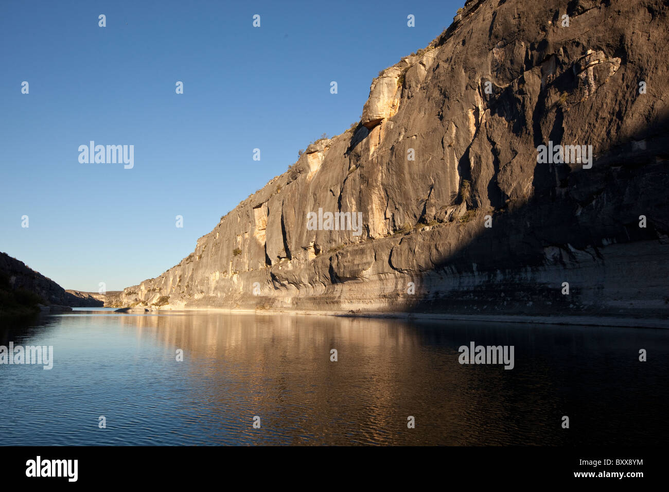 Dolomitic limestone cliffs reflected in the waters of the Pecos River ...