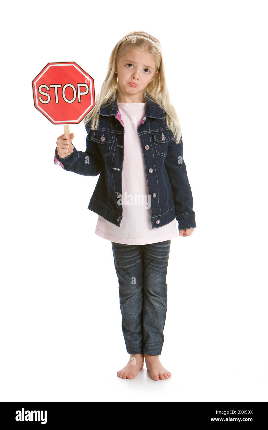 Cute little girl isolated on a white background holding a stop sign ...