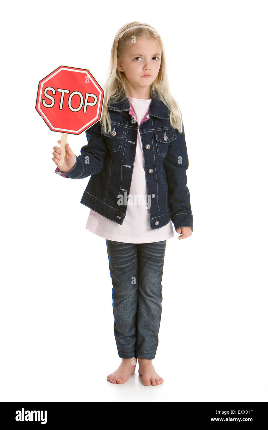 Cute little girl isolated on a white background holding a stop sign ...