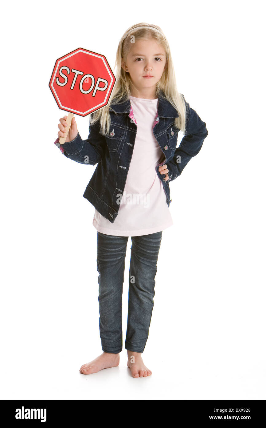 Cute little girl isolated on a white background holding a stop sign ...