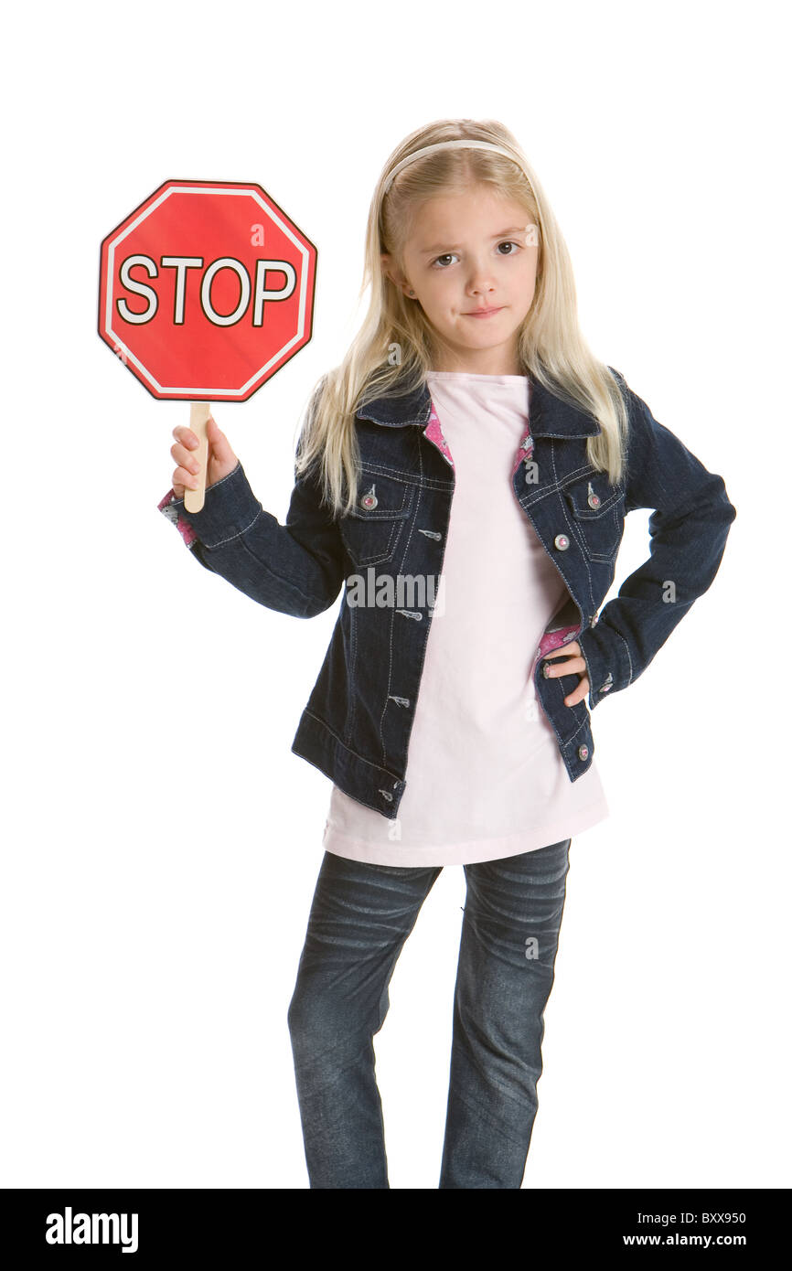Cute little girl isolated on a white background holding a stop sign ...