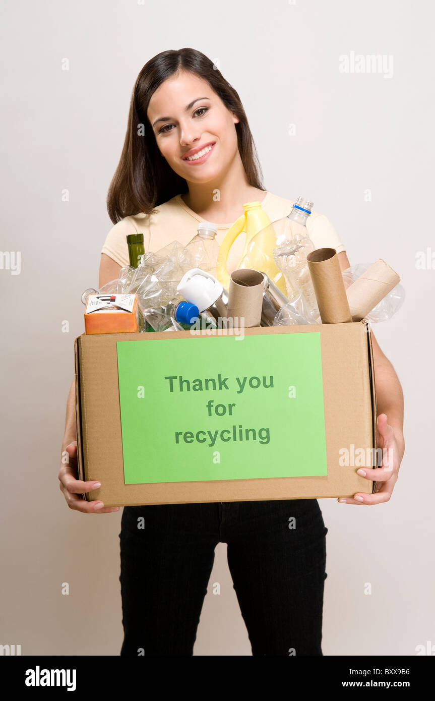 Woman holding recycling bin Stock Photo - Alamy