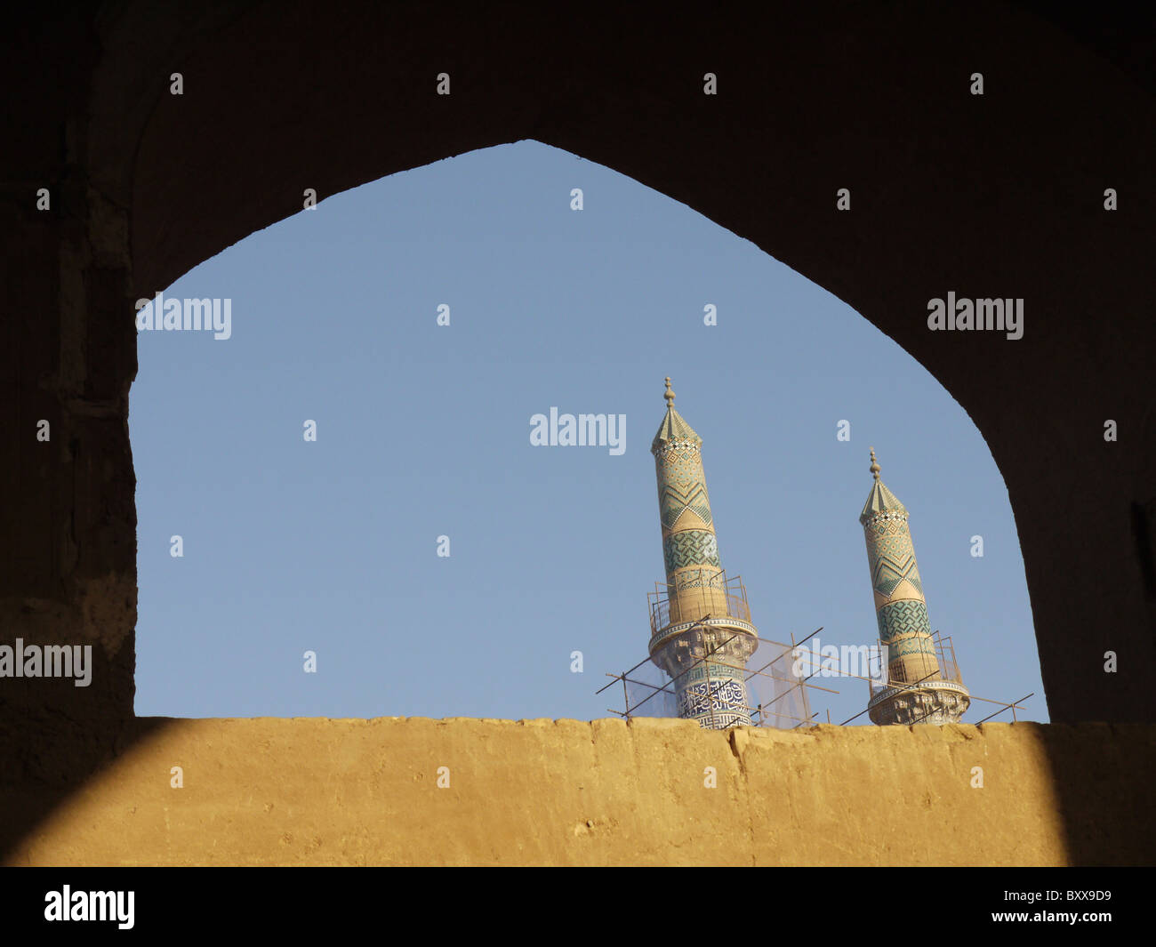 View of the Jameh Mosque minarets, Yazd, Iran through an arch Stock ...