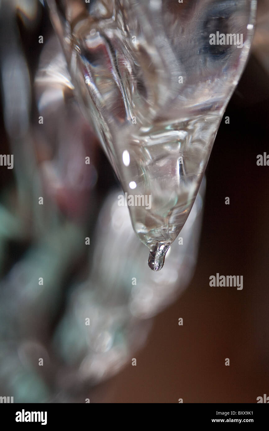 Drop of water forming to drip from an ice carving Stock Photo - Alamy