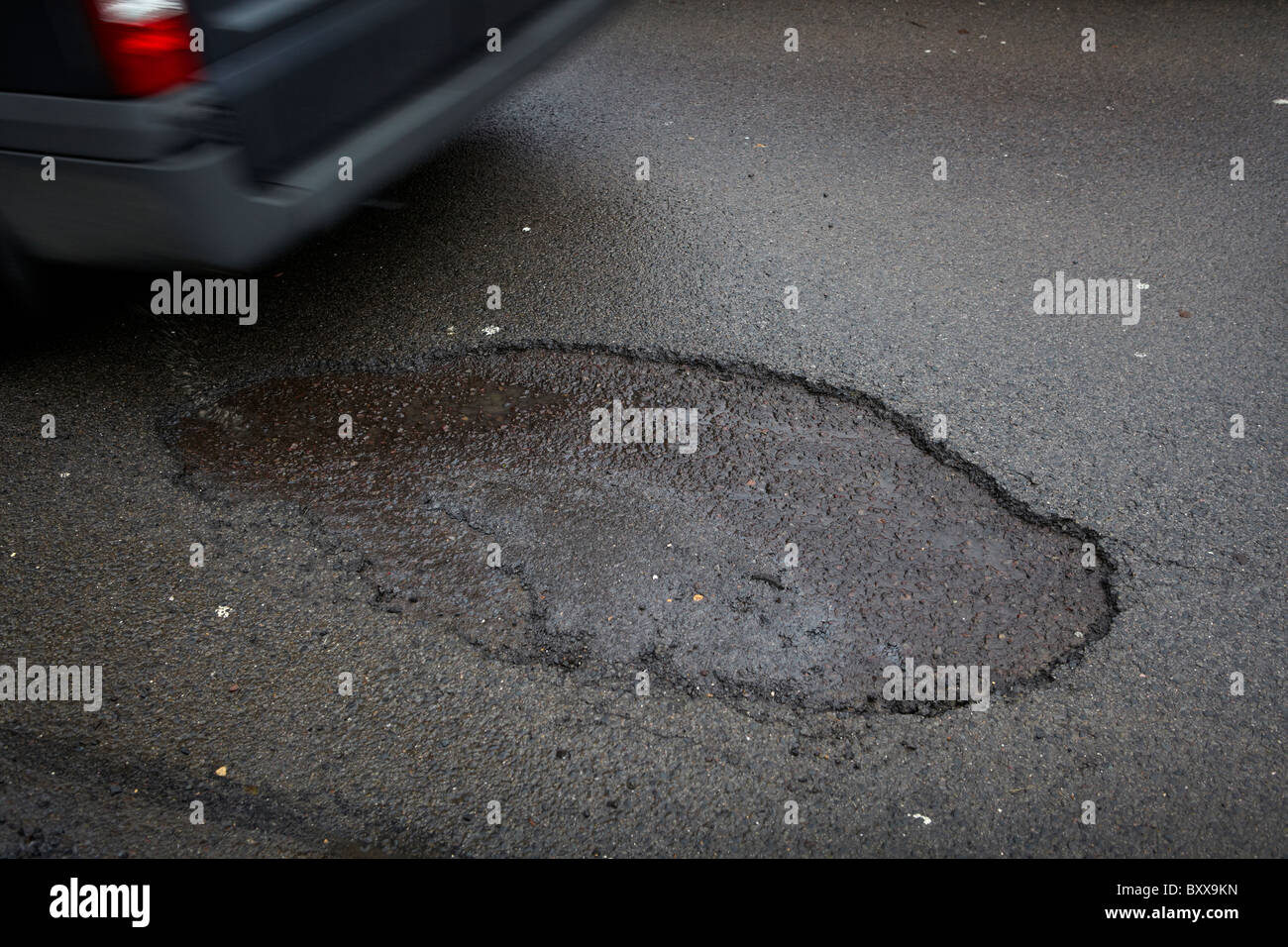 A pothole in a road Stock Photo - Alamy