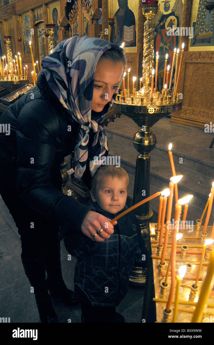 RUSSIA. WOMAN AND CHILD LIGHTING CANDLES DURING CHRISTMAS CELEBRATIONS ...