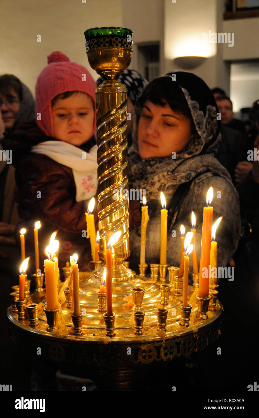 RUSSIA. WOMAN AND CHILD LIGHTING CANDLES DURING CHRISTMAS CELEBRATIONS ...
