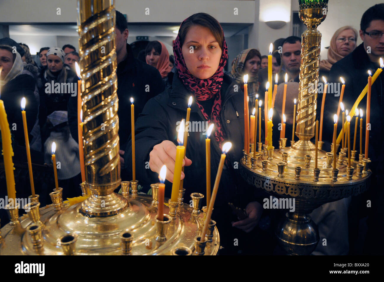 RUSSIA. WOMAN LIGHTING CANDLES DURING CHRISTMAS CELEBRATIONS AT RUSSIAN ...