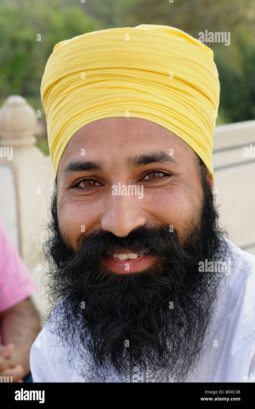 Indian Sikh in yellow turban and beard, Taj Mahal, a mausoleum located ...