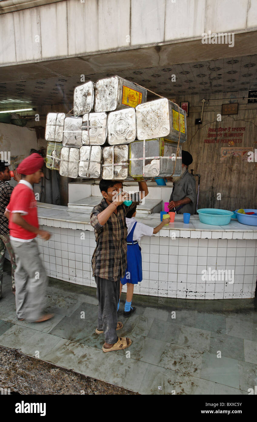 Man transporting water cans on his head, Delhi, India Stock Photo - Alamy