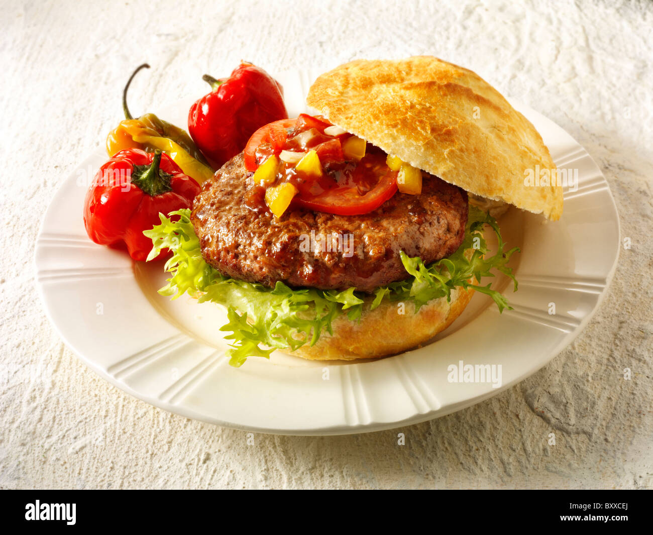 Home made burger in a crusty roll with tomato sweetcorn relish and ...