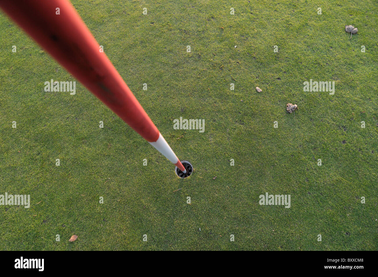 Golfing post and putting green Stock Photo - Alamy