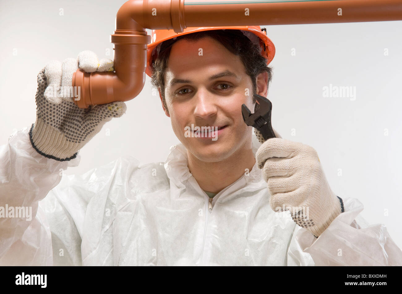plumber using wrench on pipe Stock Photo - Alamy