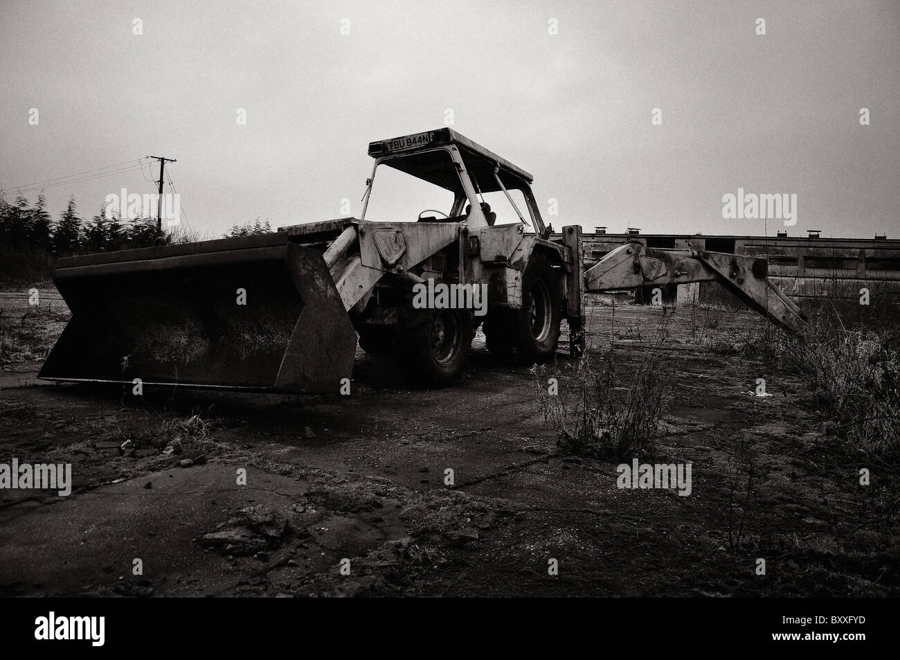 Derelict industrial machinery JCB worn weathered rust rusty cold winter ...