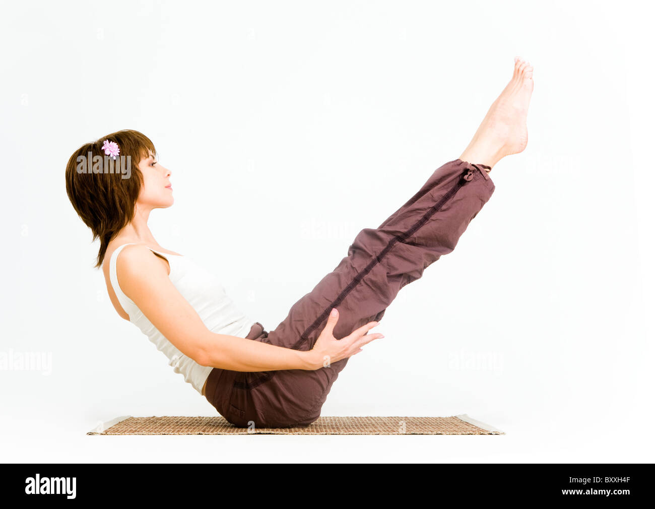 Young woman doing an exercise – raise her body and legs Stock Photo - Alamy