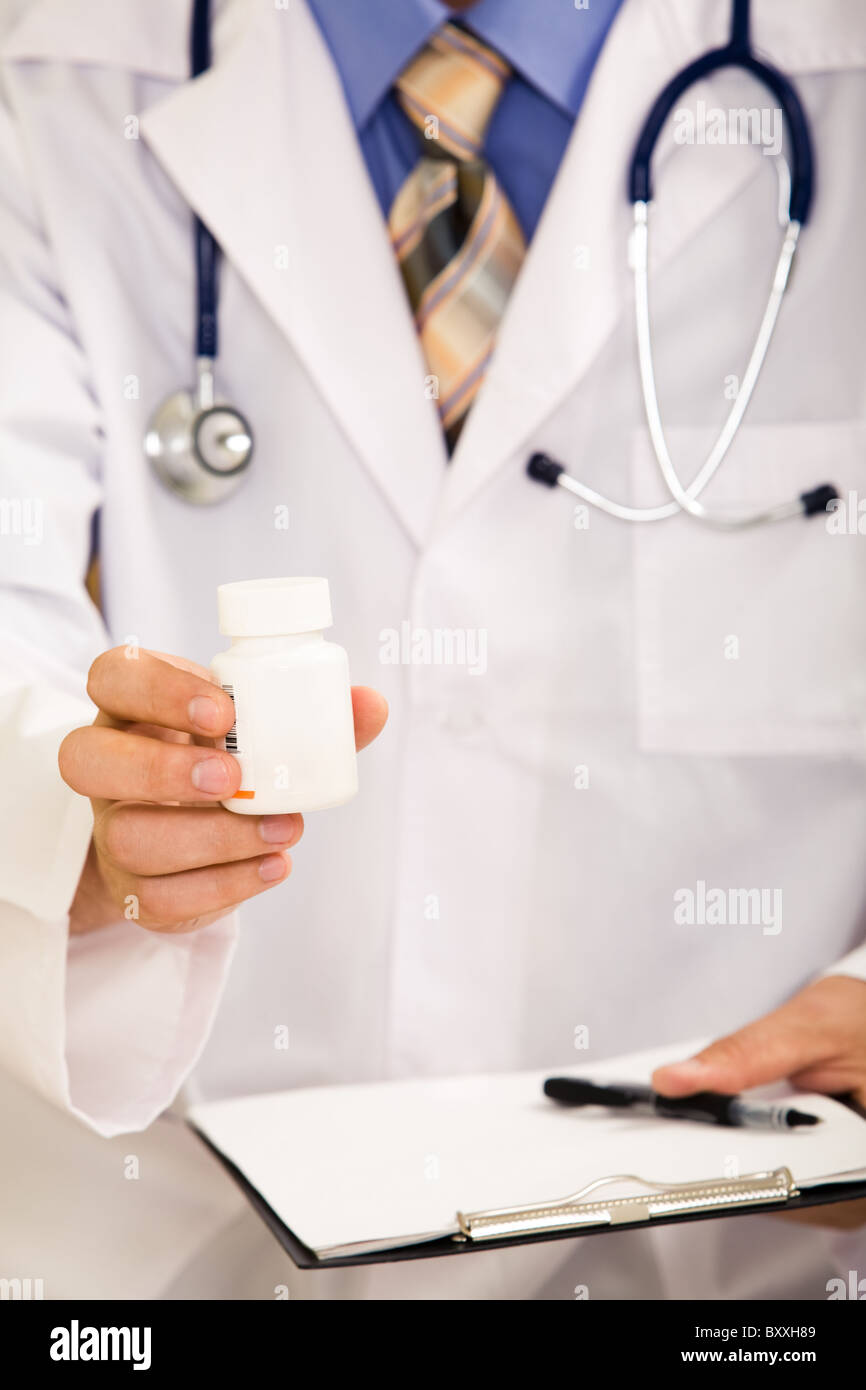 Close-up of doctor’s hand holding medicine and giving it to his patient ...