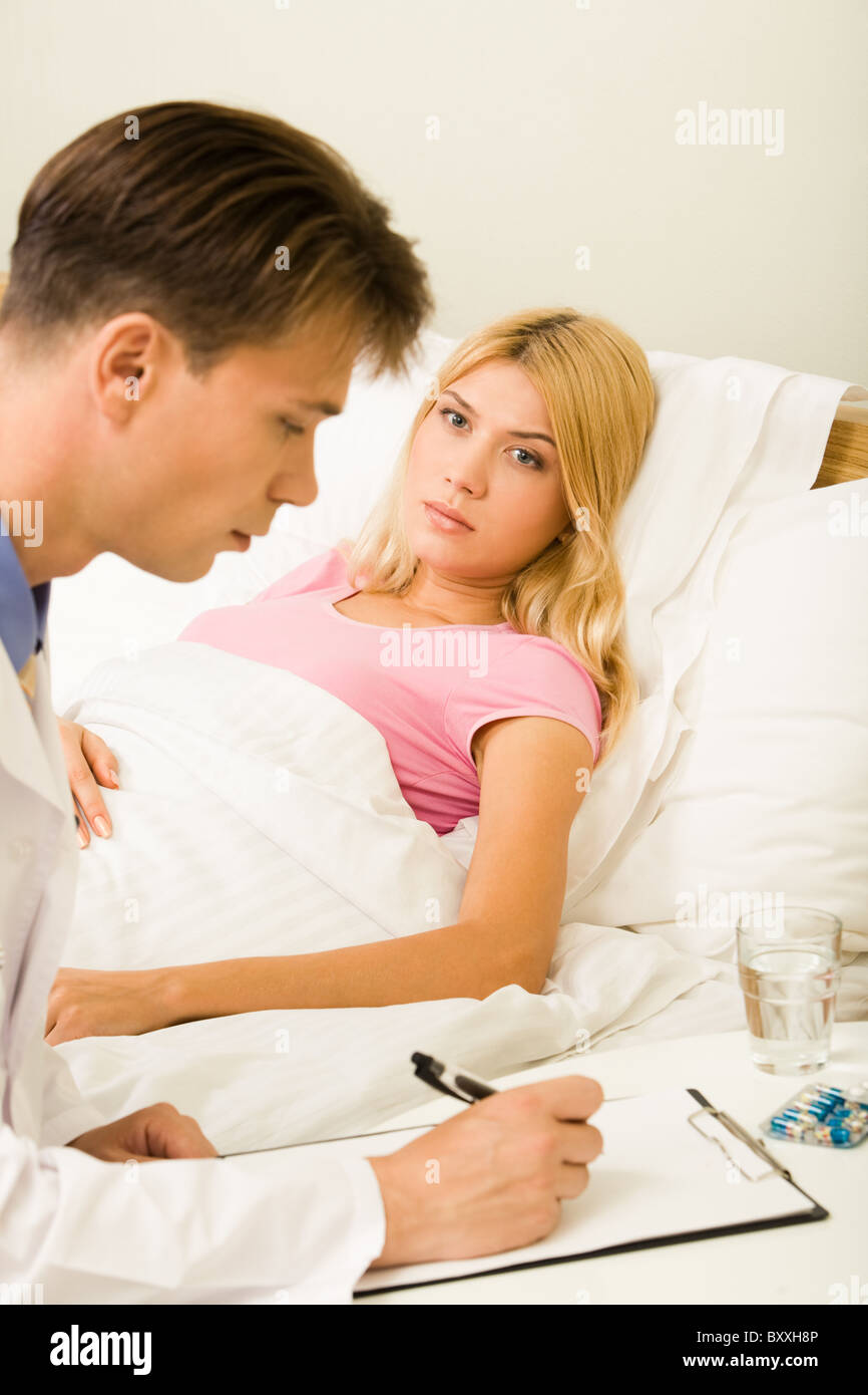 Vertical image of practitioner prescribing medication to a young ill ...