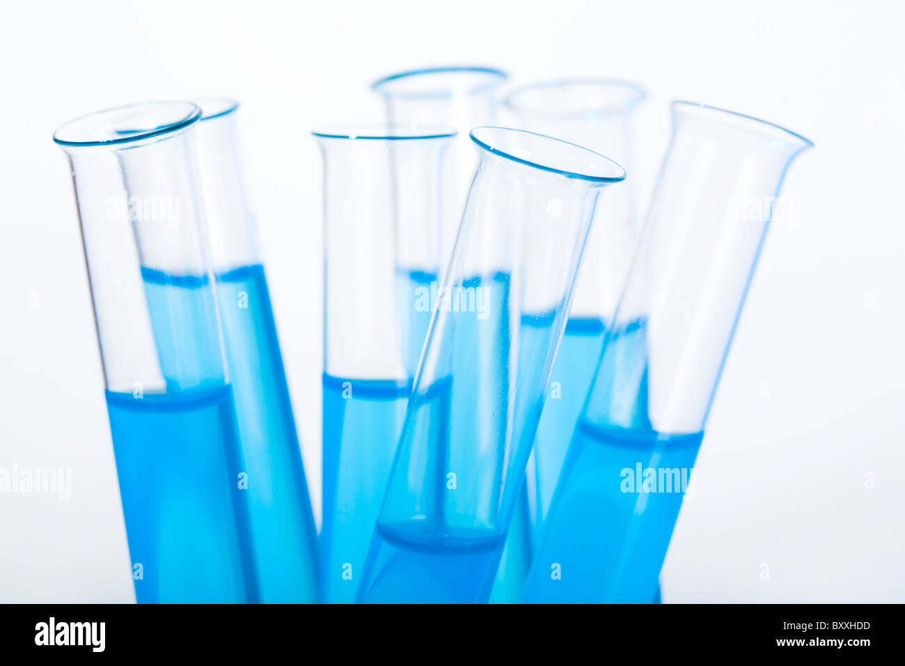 Image of several medical flasks with blue water on a white background ...