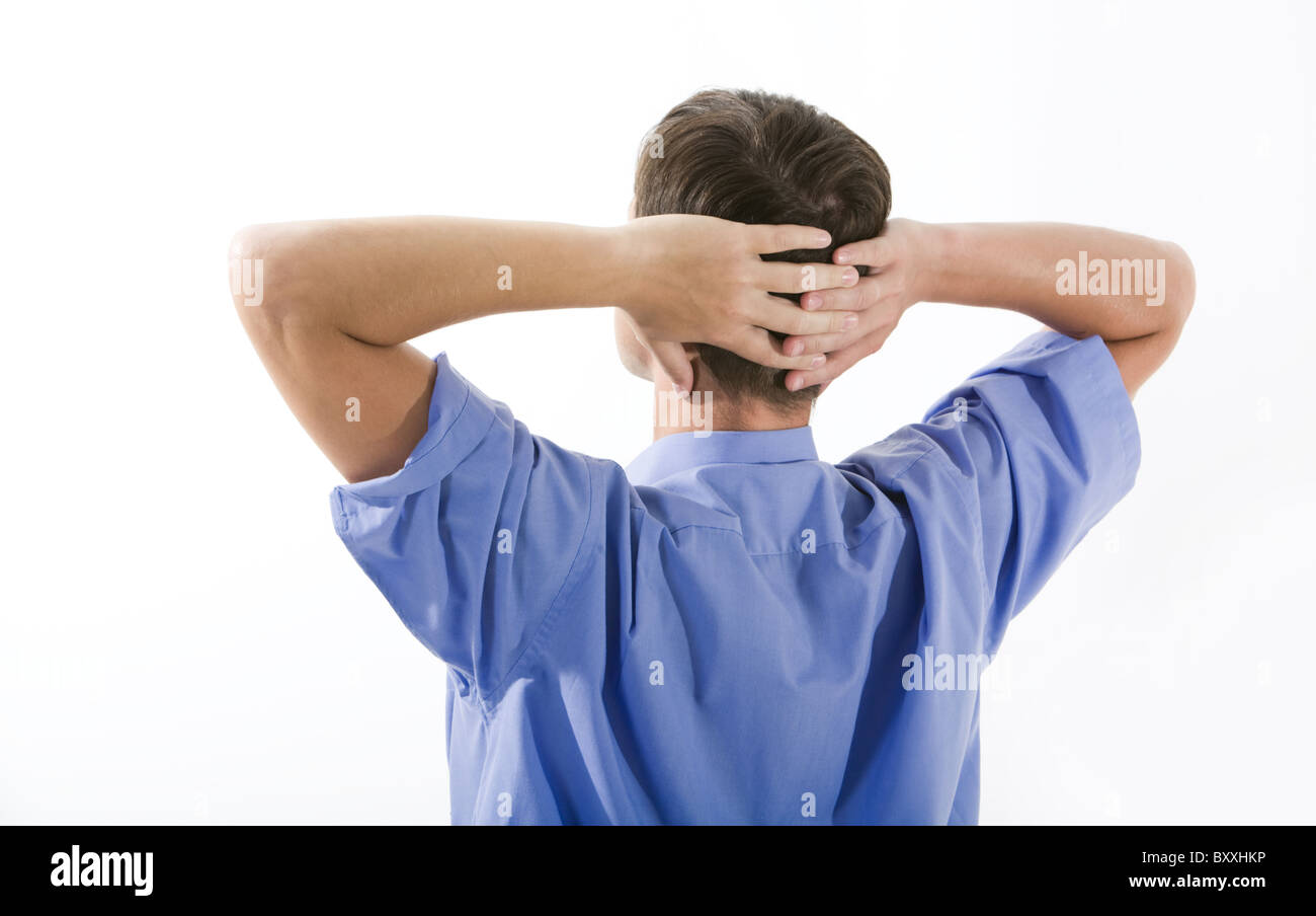 Rear view of male with hands behind head over white background Stock ...