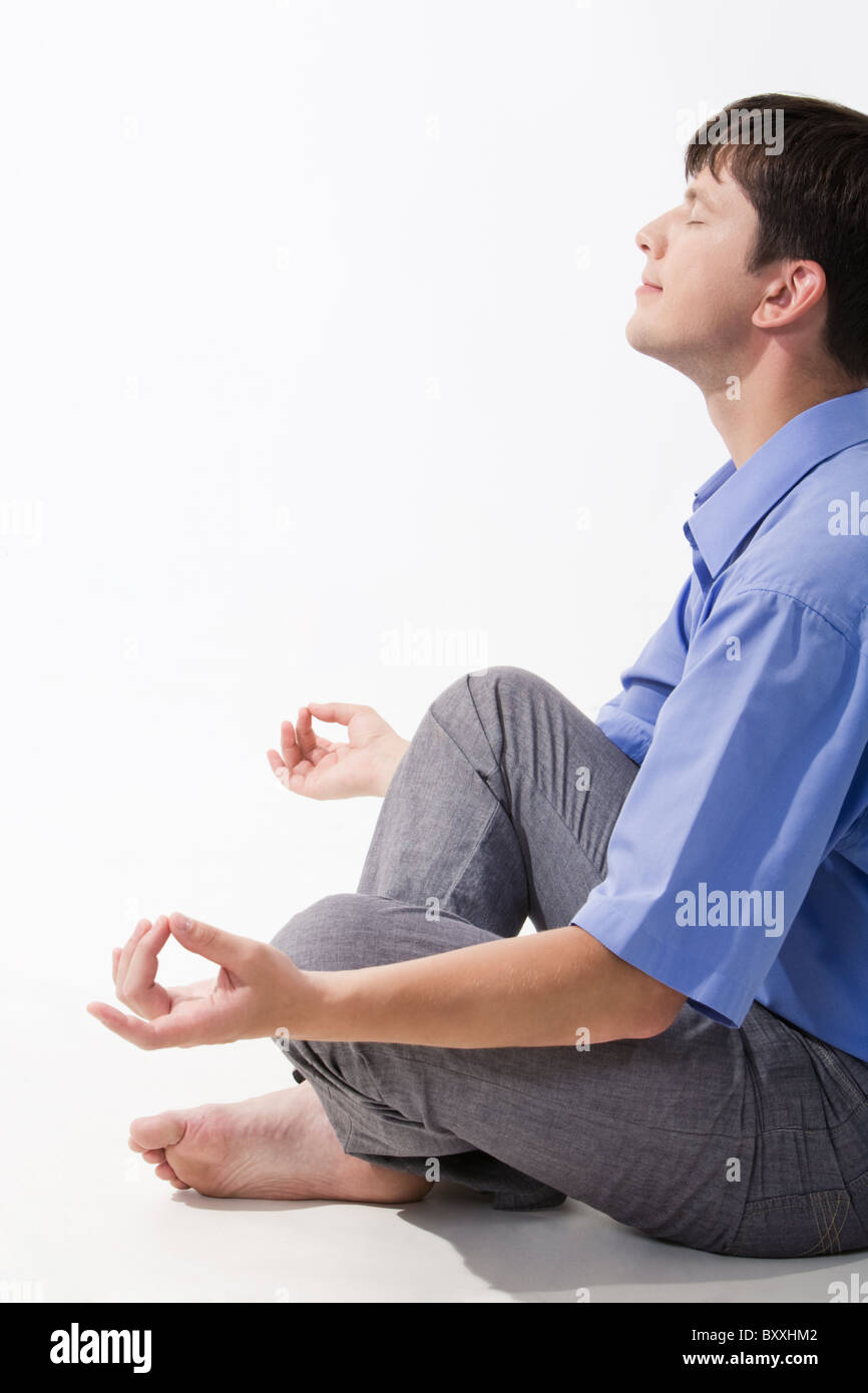 View of man doing yoga exercise and taking pleasure in it Stock Photo ...