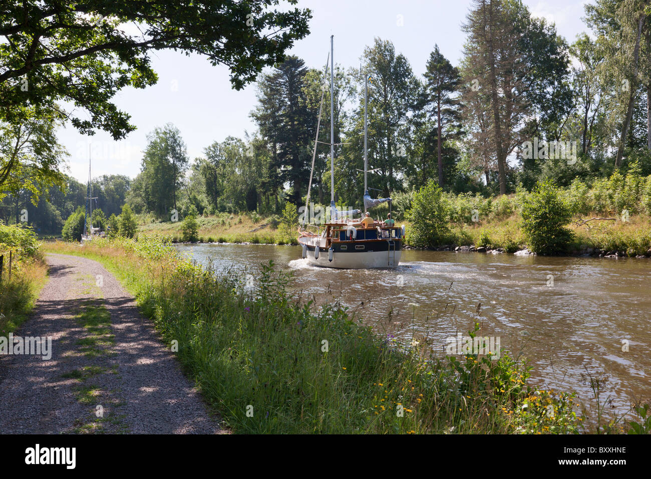 Sailing boat on the canal lined with trees Stock Photo - Alamy
