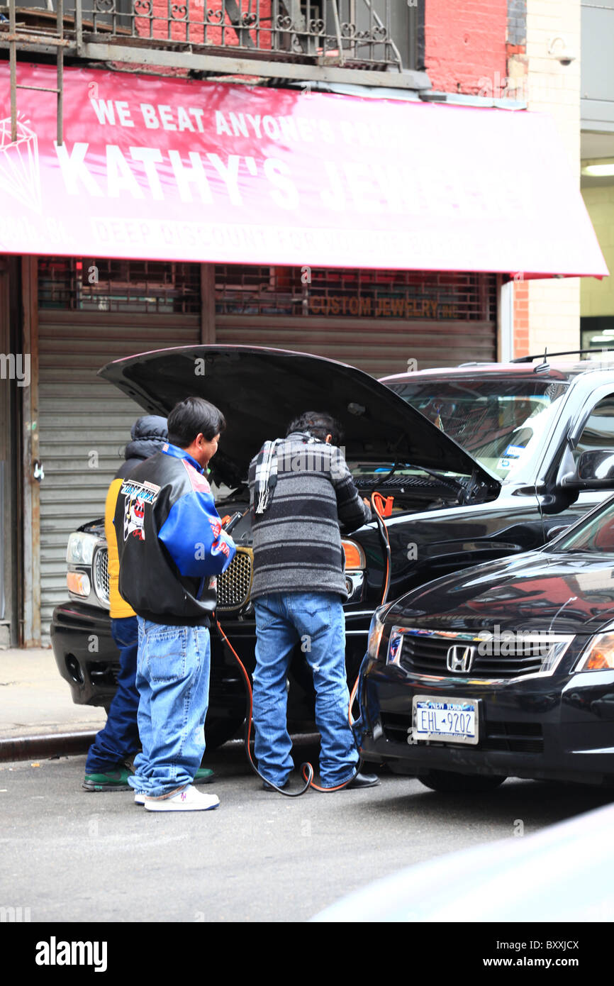 Jump starting a car on street in New York city, 2010 Stock Photo - Alamy