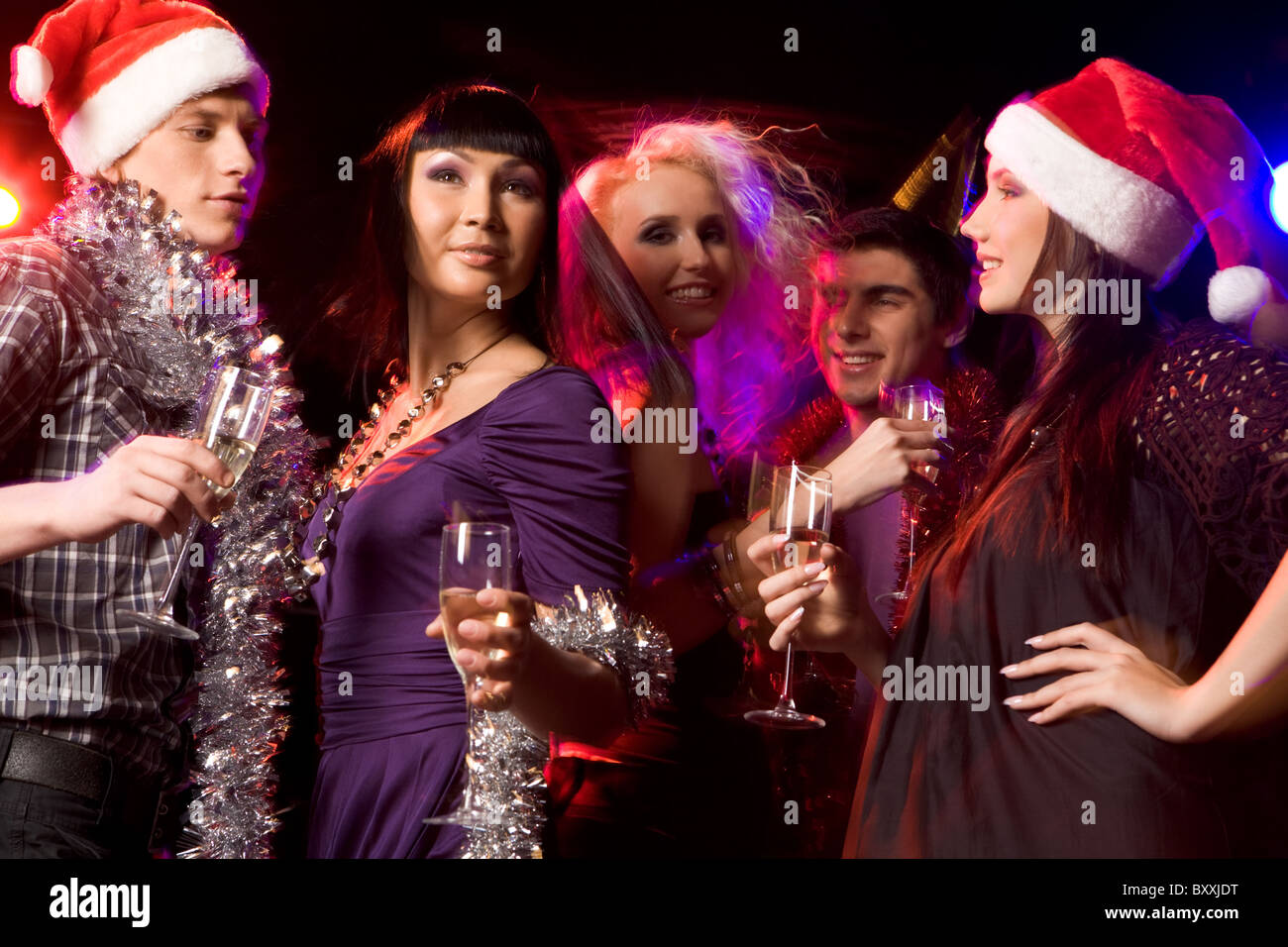 Happy friends with champagne dancing in night club during party Stock ...