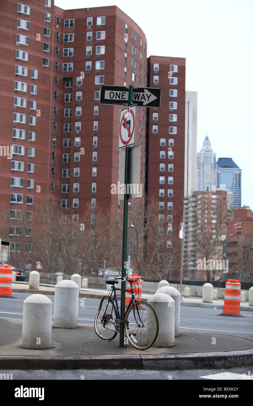 Damaged bicycle chained to traffic sign pole in New York city Stock ...