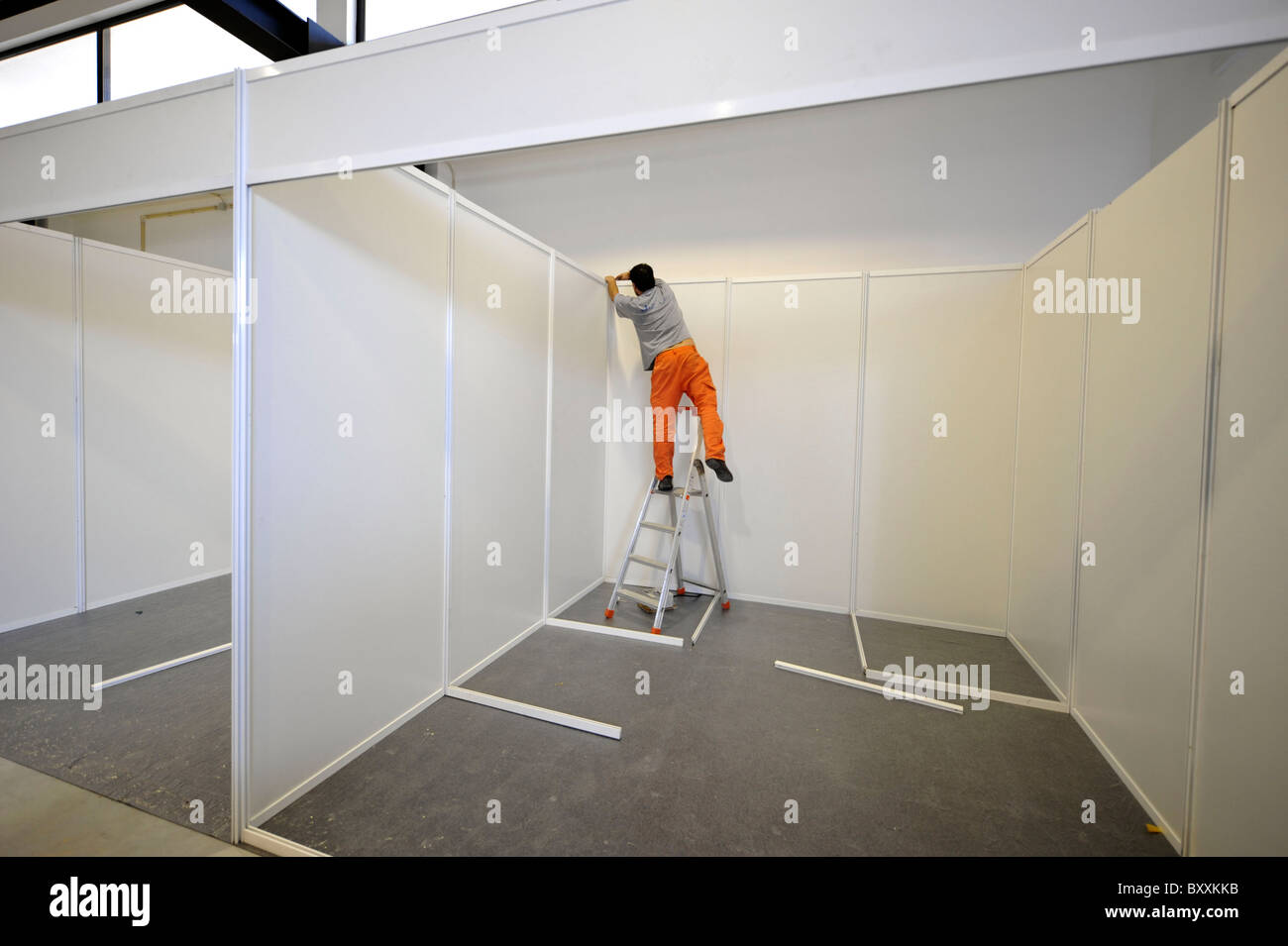Man working on top of step ladder Stock Photo - Alamy