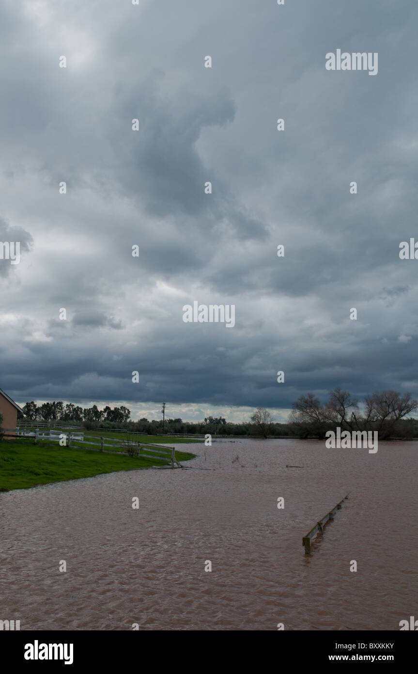 Fence underwater, from flooding from rainstorms in December 2010, near ...
