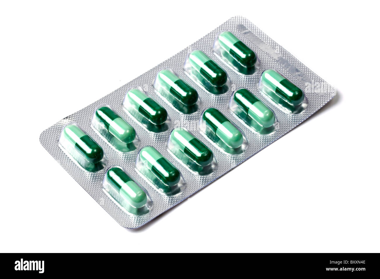 Package of green capsules isolated on white background Stock Photo - Alamy