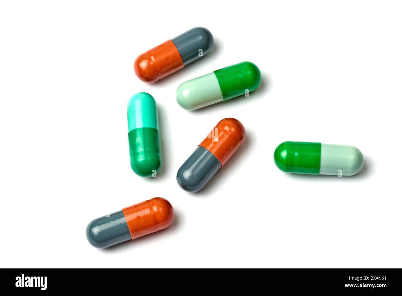A few colorful capsules isolated on white background Stock Photo - Alamy