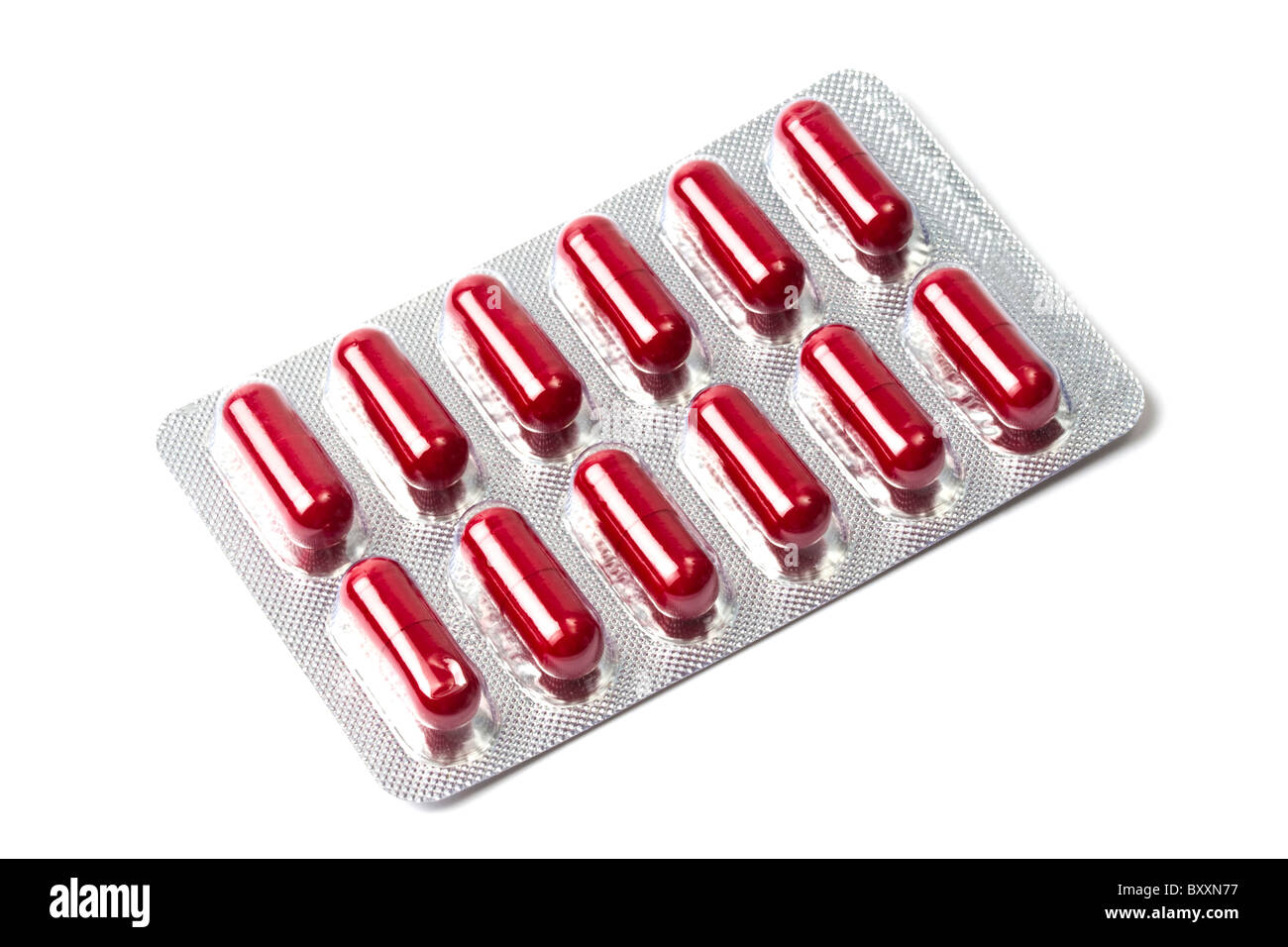 Red capsules packed in blister isolated on white Stock Photo - Alamy