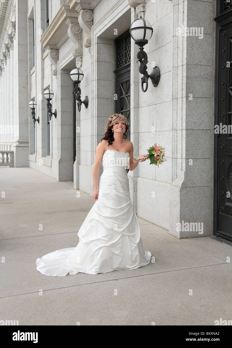 bride walking and laughing outside large building Stock Photo - Alamy