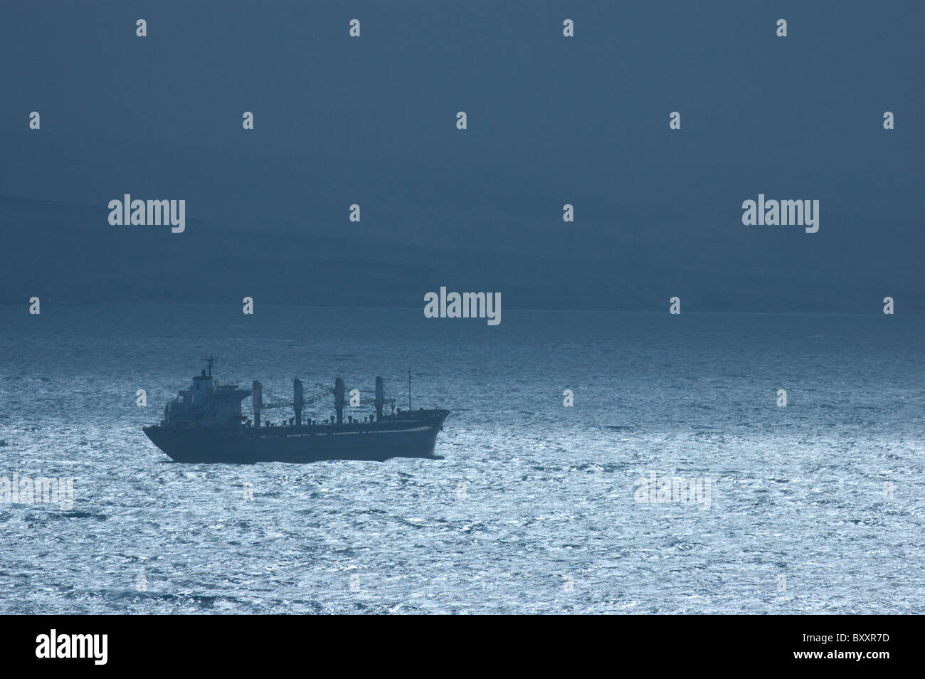 Dry bulk freighter sailing away into the distance Stock Photo - Alamy