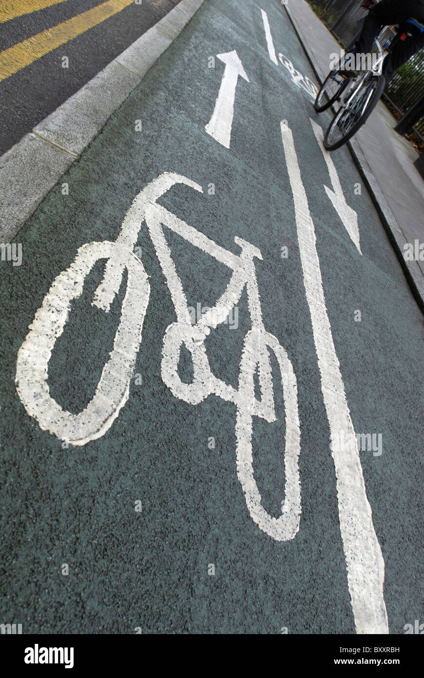 Cyclist on two way cycle lane on urban street UK Stock Photo - Alamy