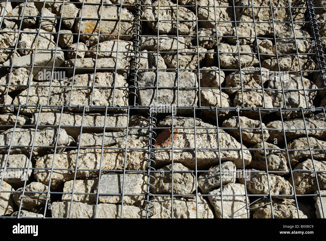 Wire mesh protecting stone wall Stock Photo - Alamy