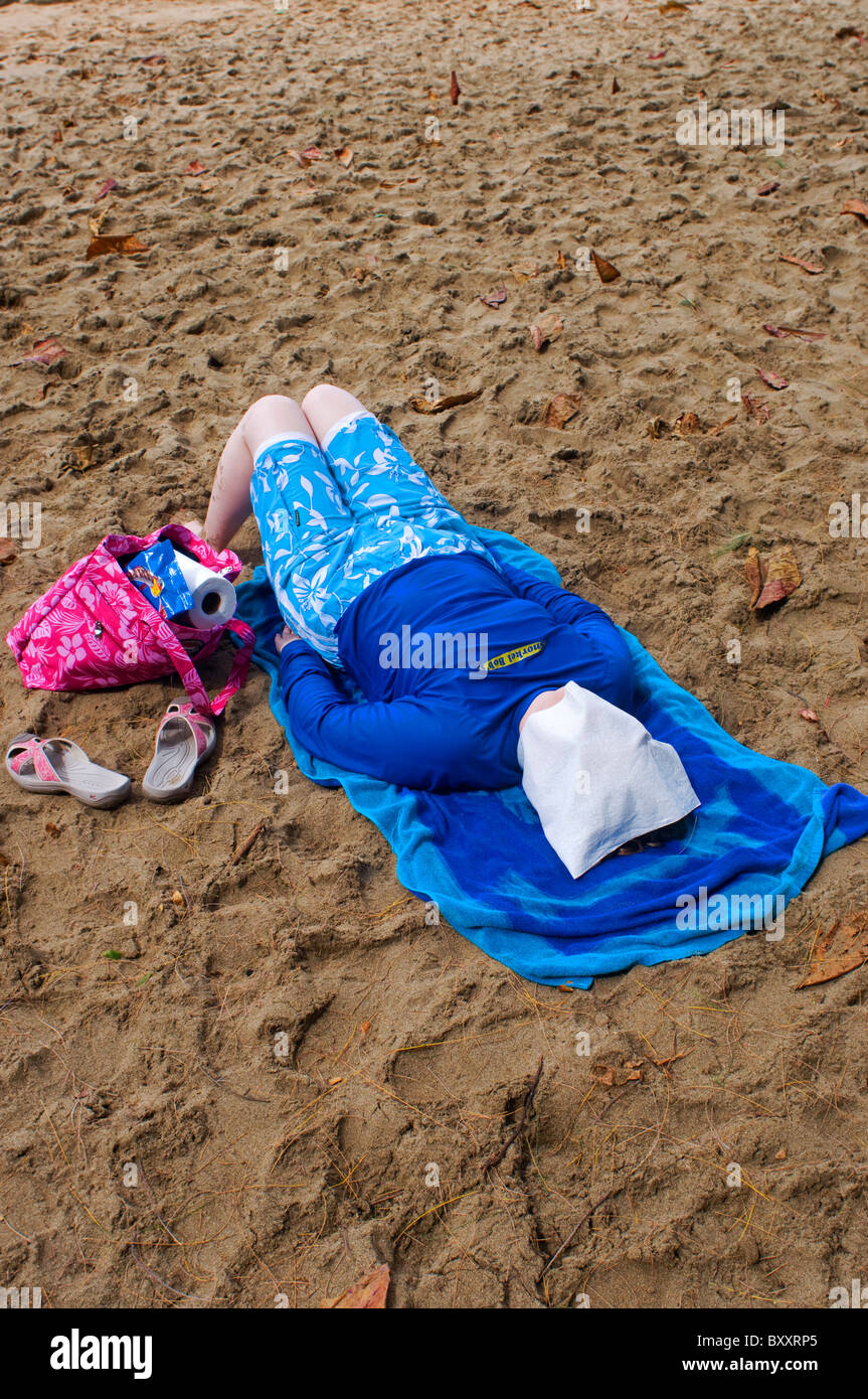 Tourist sleeping on sandy beach Stock Photo - Alamy