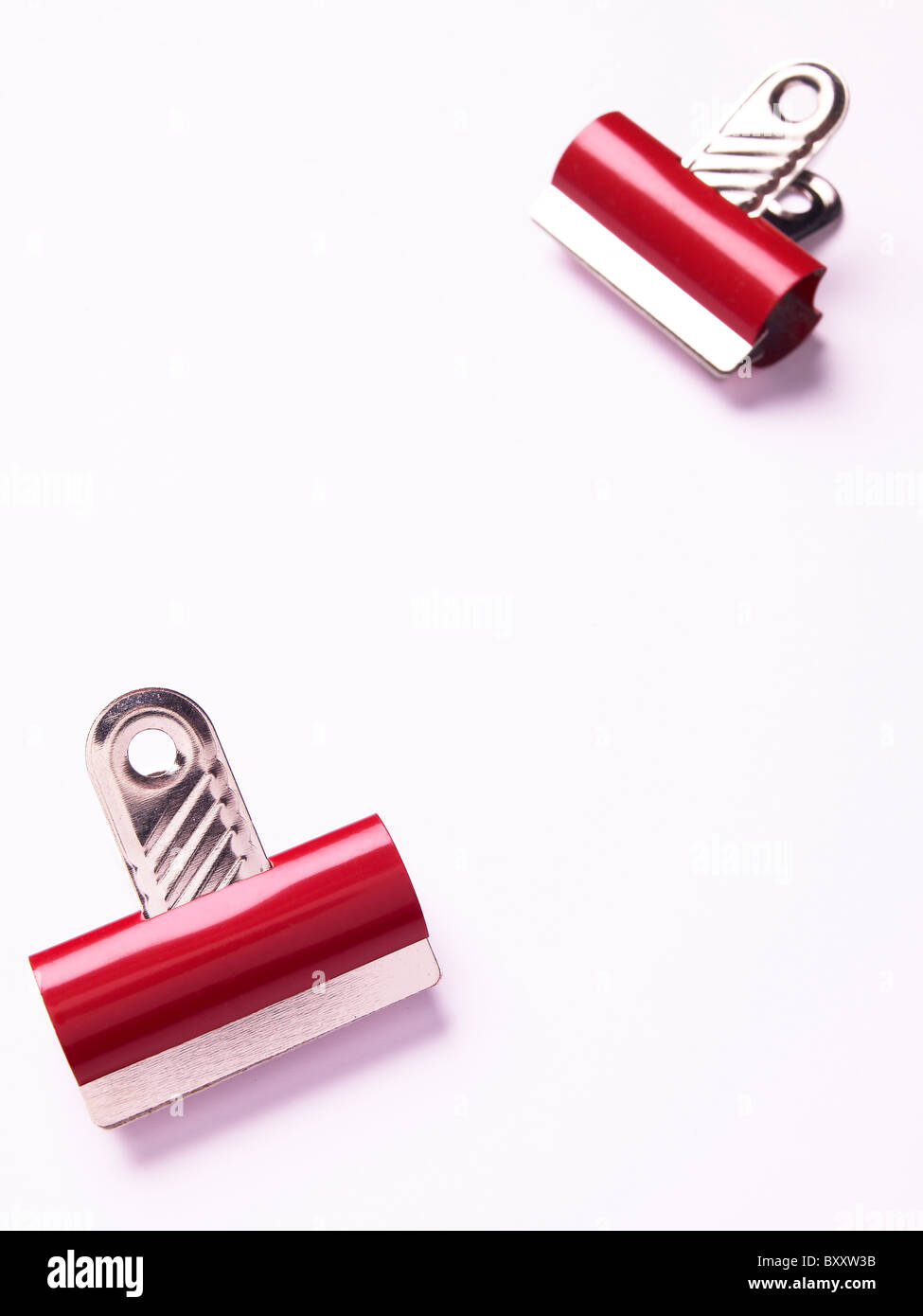 2 two red bulldog clips on a white background Stock Photo - Alamy