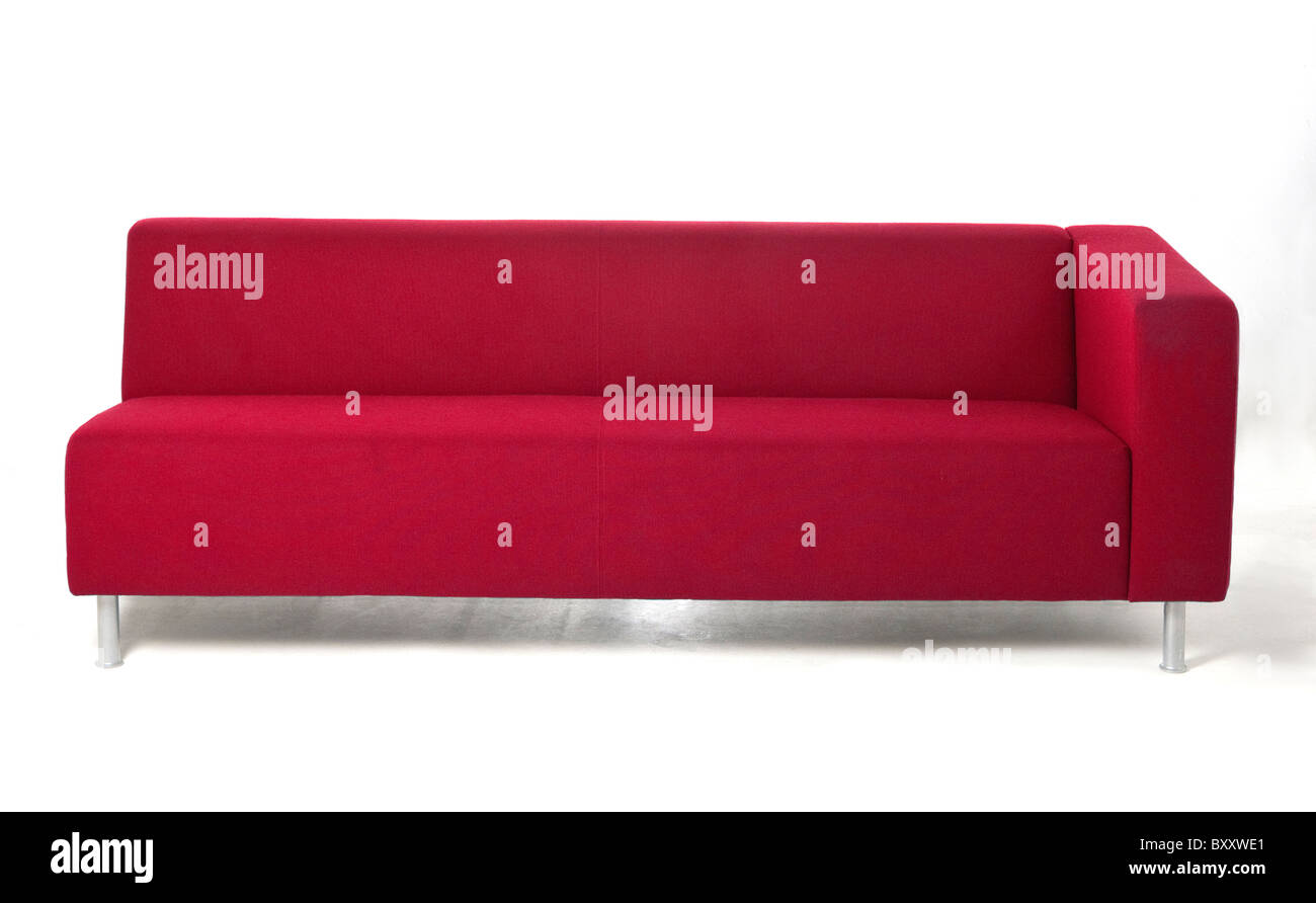 Modern red sofa in a studio location Stock Photo - Alamy