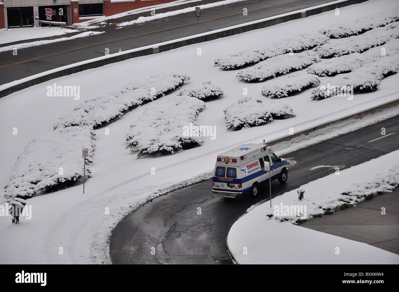 Local ambulance responding to an emergency call after snow storm on ...