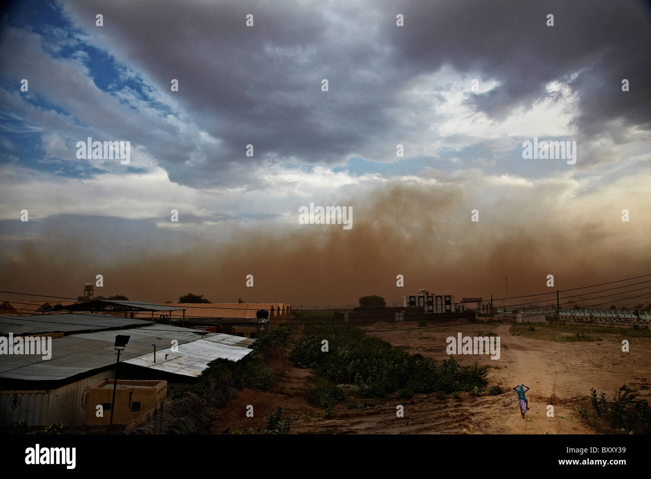 A haboob blows in over Darfur as a woman takes cover Stock Photo - Alamy