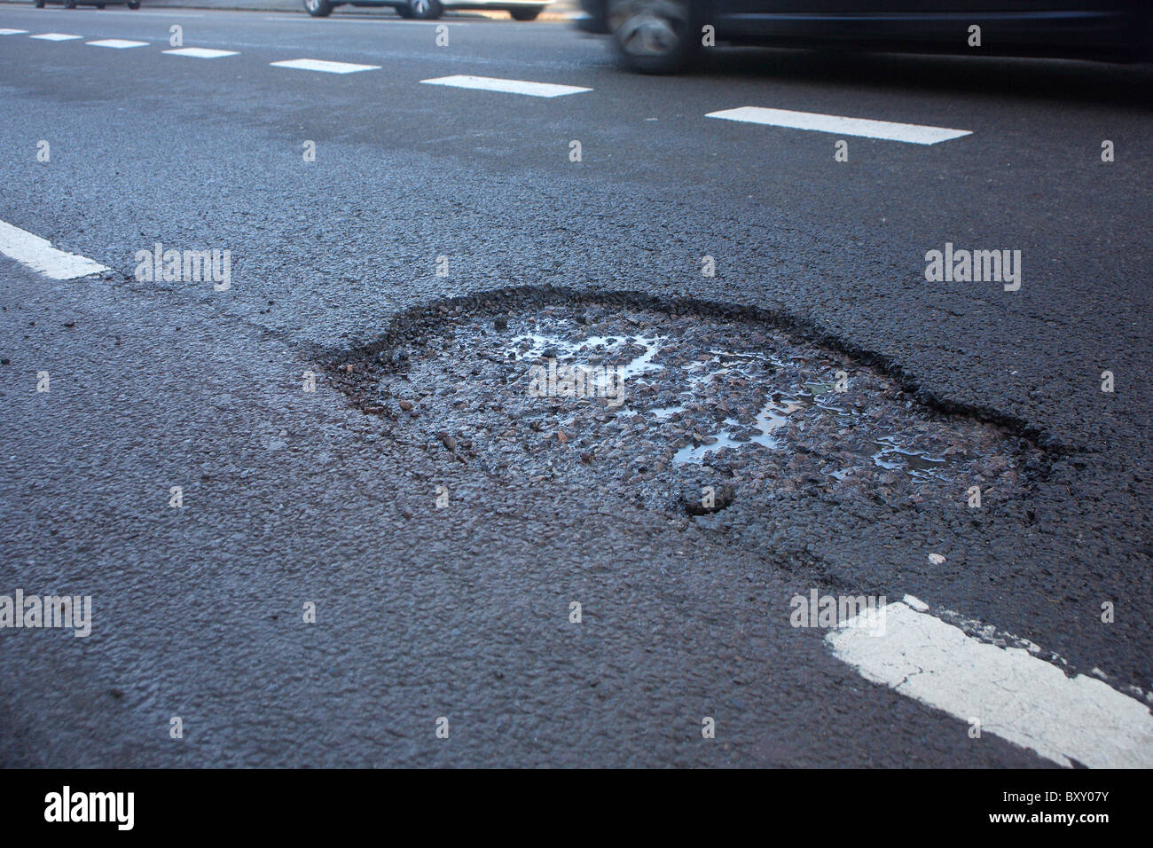 Pothole in a road Stock Photo - Alamy