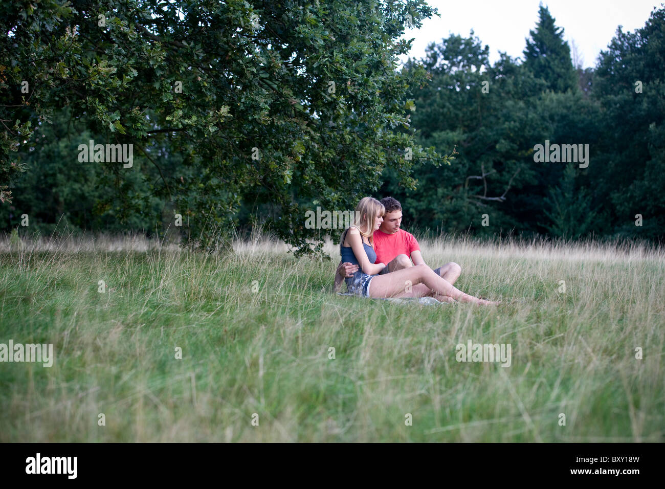 Intimate couple on grass hi-res stock photography and images - Alamy