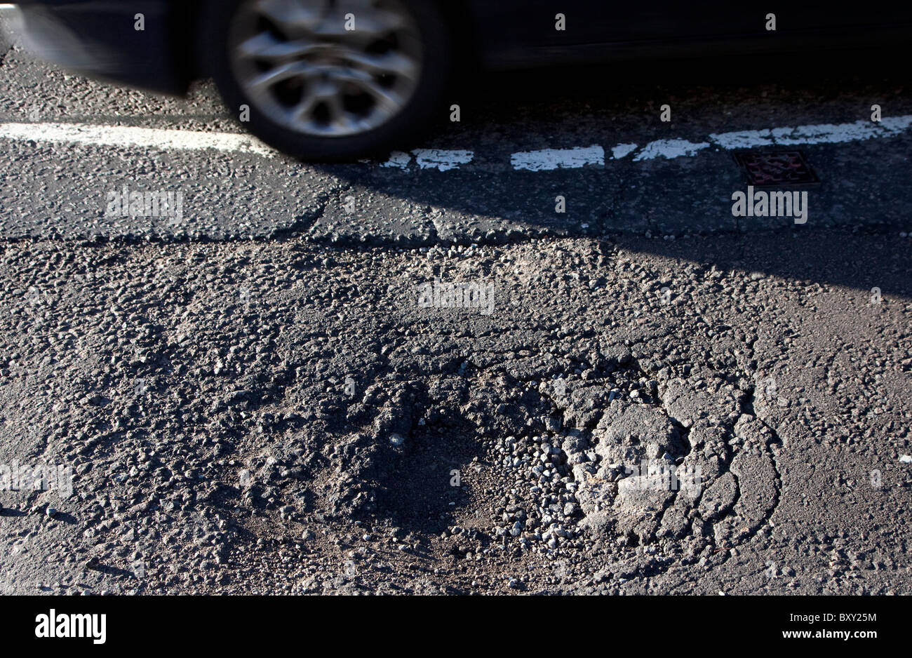 Pothole in London street after severe winter weather Stock Photo - Alamy