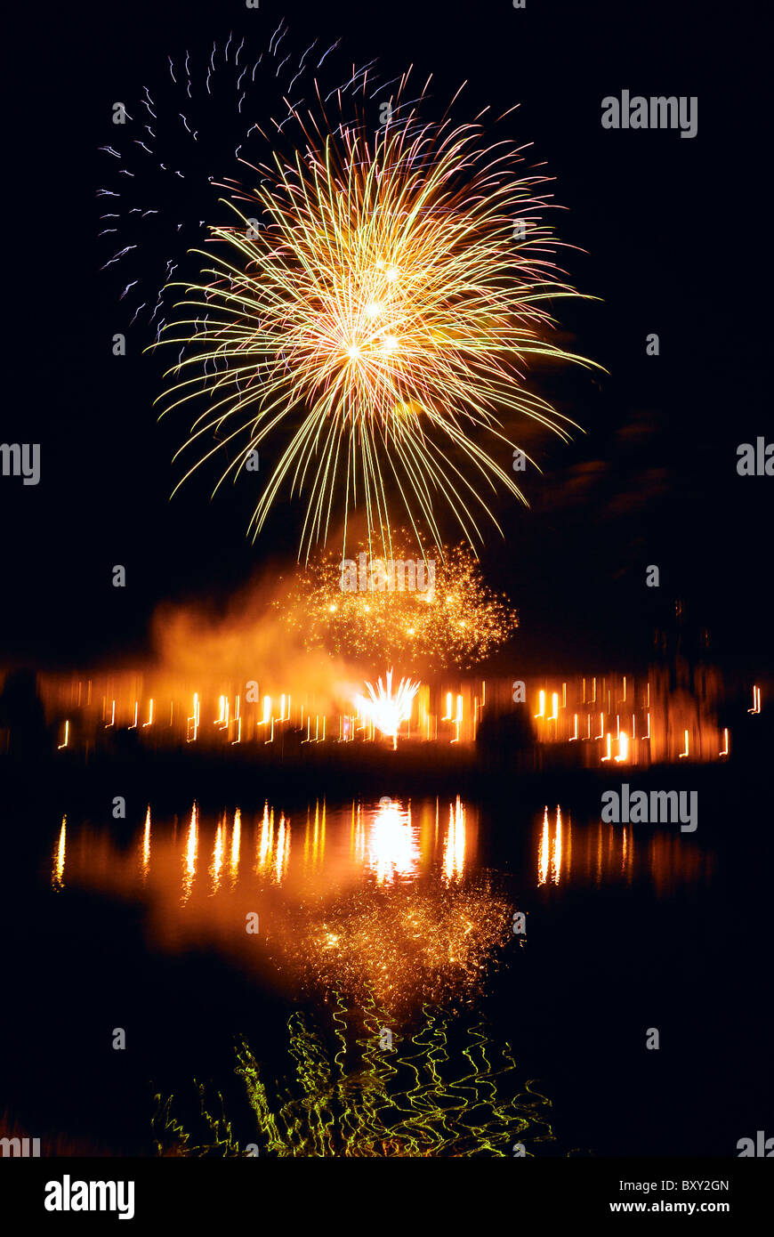 night traditional firework with reflection in water Stock Photo - Alamy
