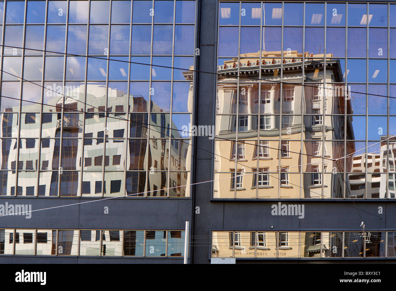 Reflected buildings in the glass frontage of a new tower block Stock ...
