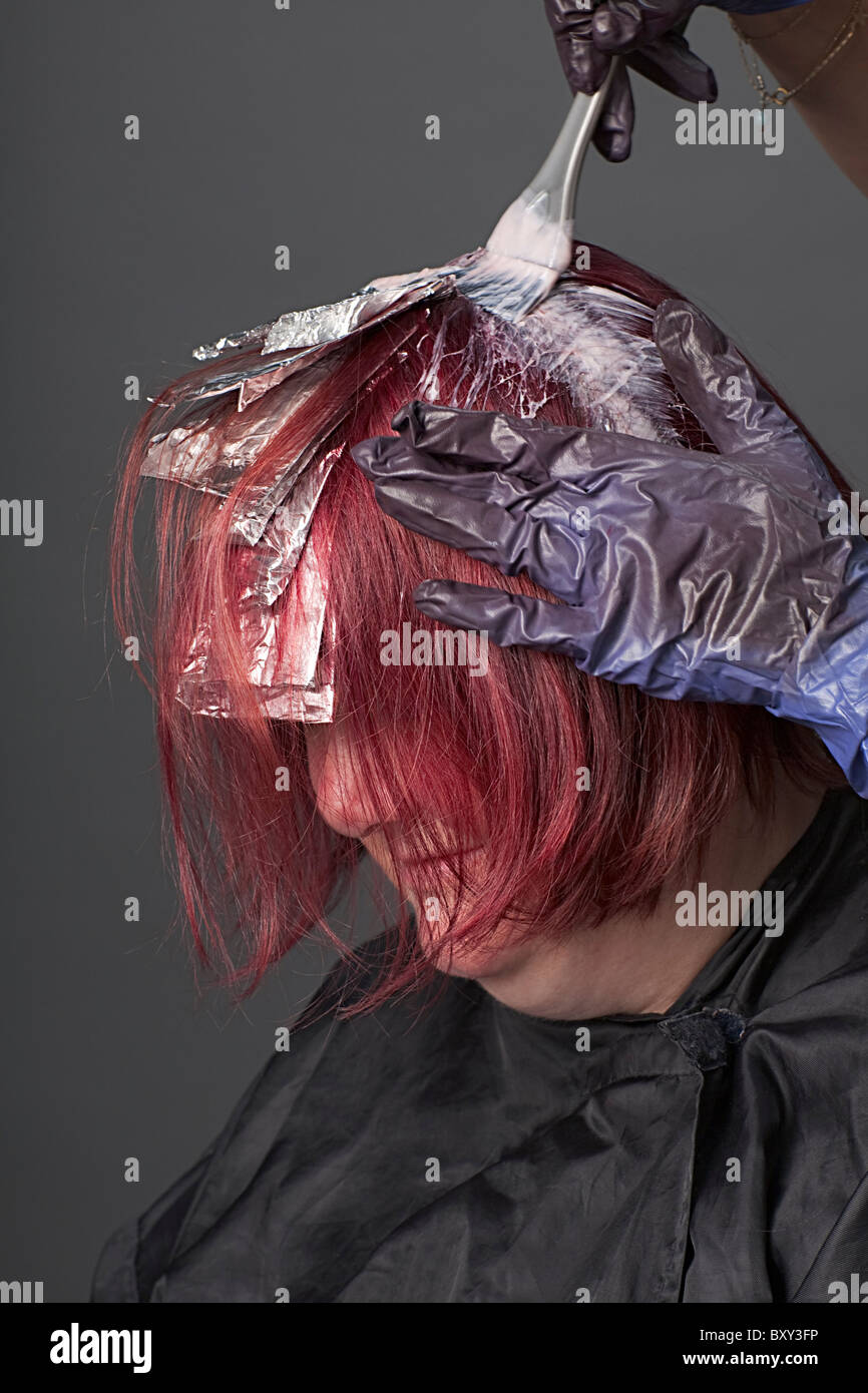 Woman applying hair colour dyeing hi-res stock photography and images ...